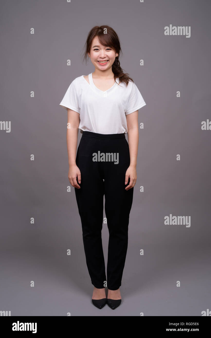 Full length shot of young Asian woman standing Stock Photo - Alamy