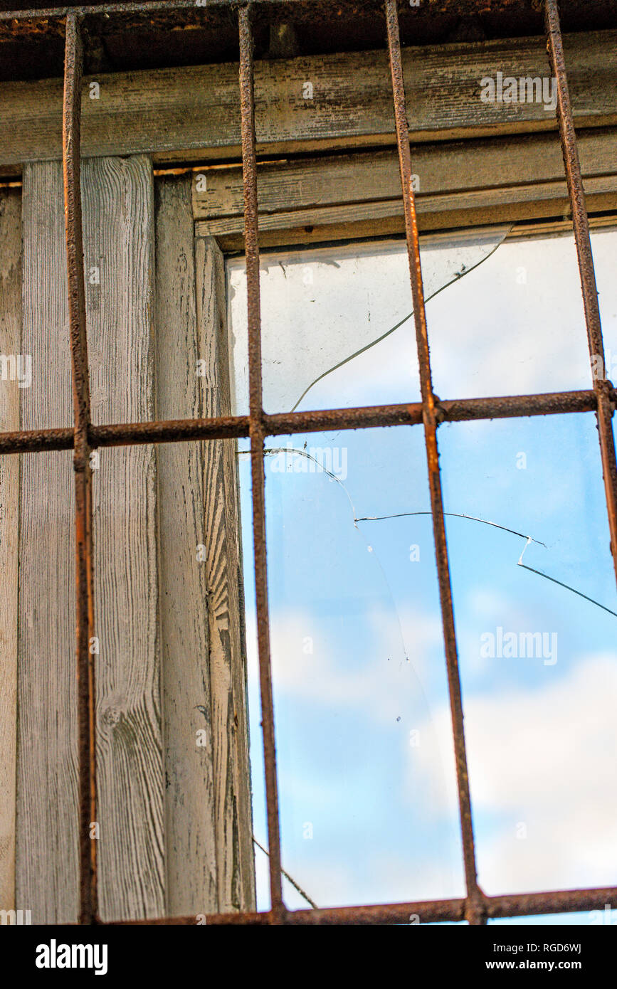 window with broken glass and view to the blue sky with clouds Stock ...