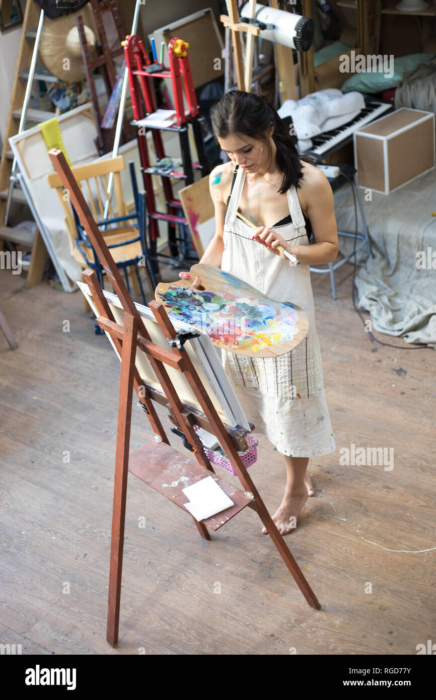 Woman artist painting picture in art studio. Female artist, drawing ...