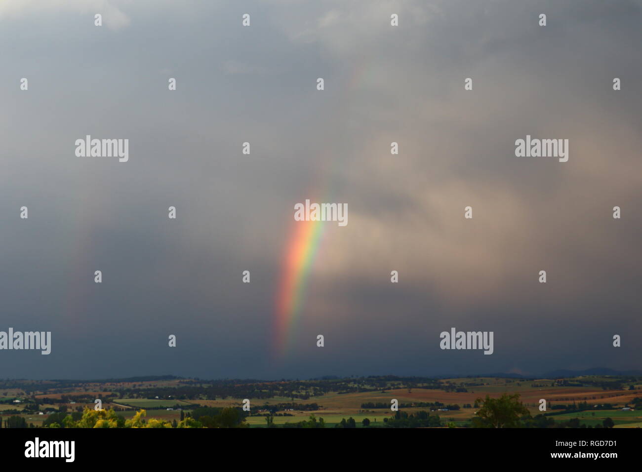 A rainbow far away Stock Photo - Alamy