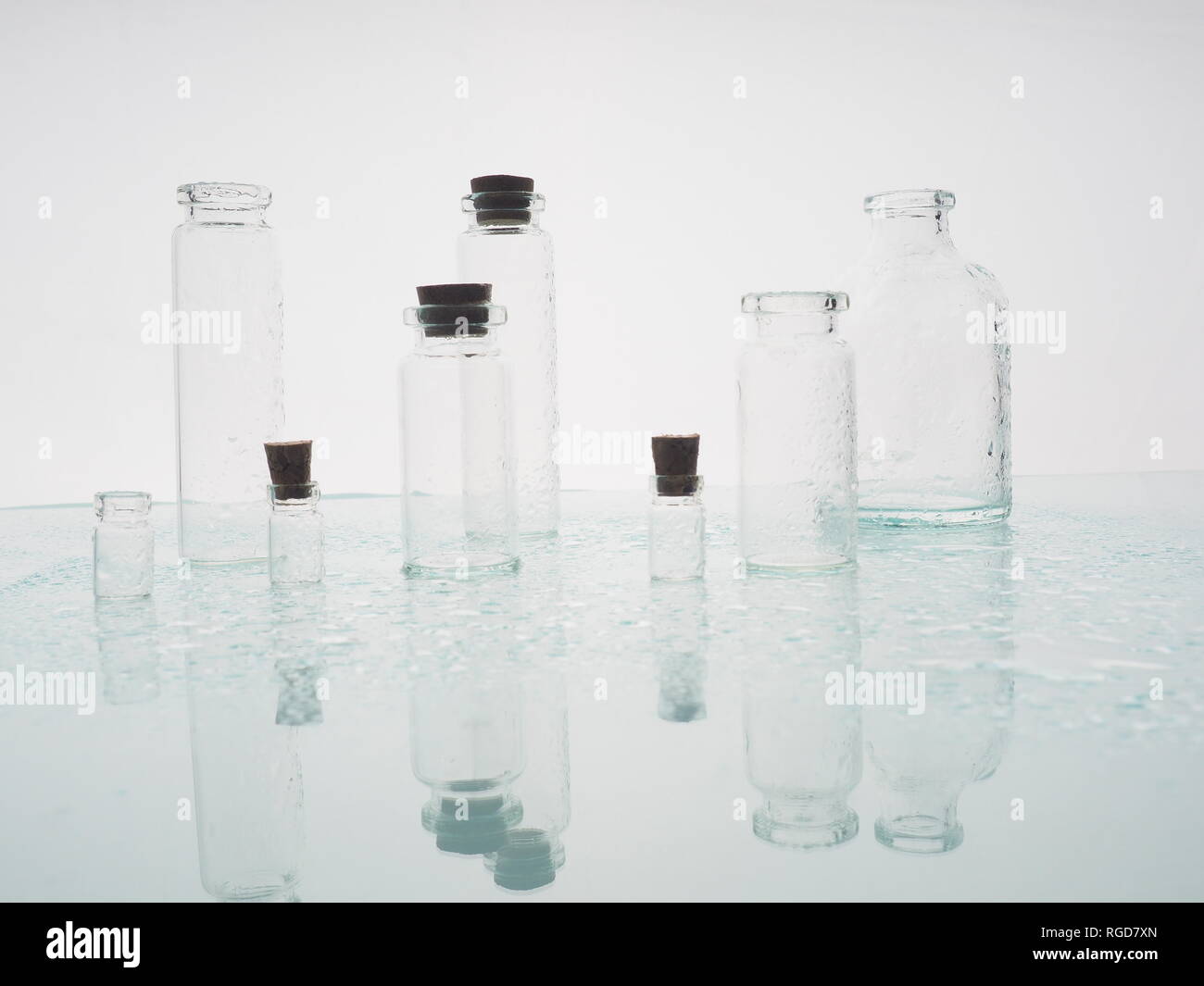 Few transparent bottles, water sprays. empty glass bottles Stock Photo ...