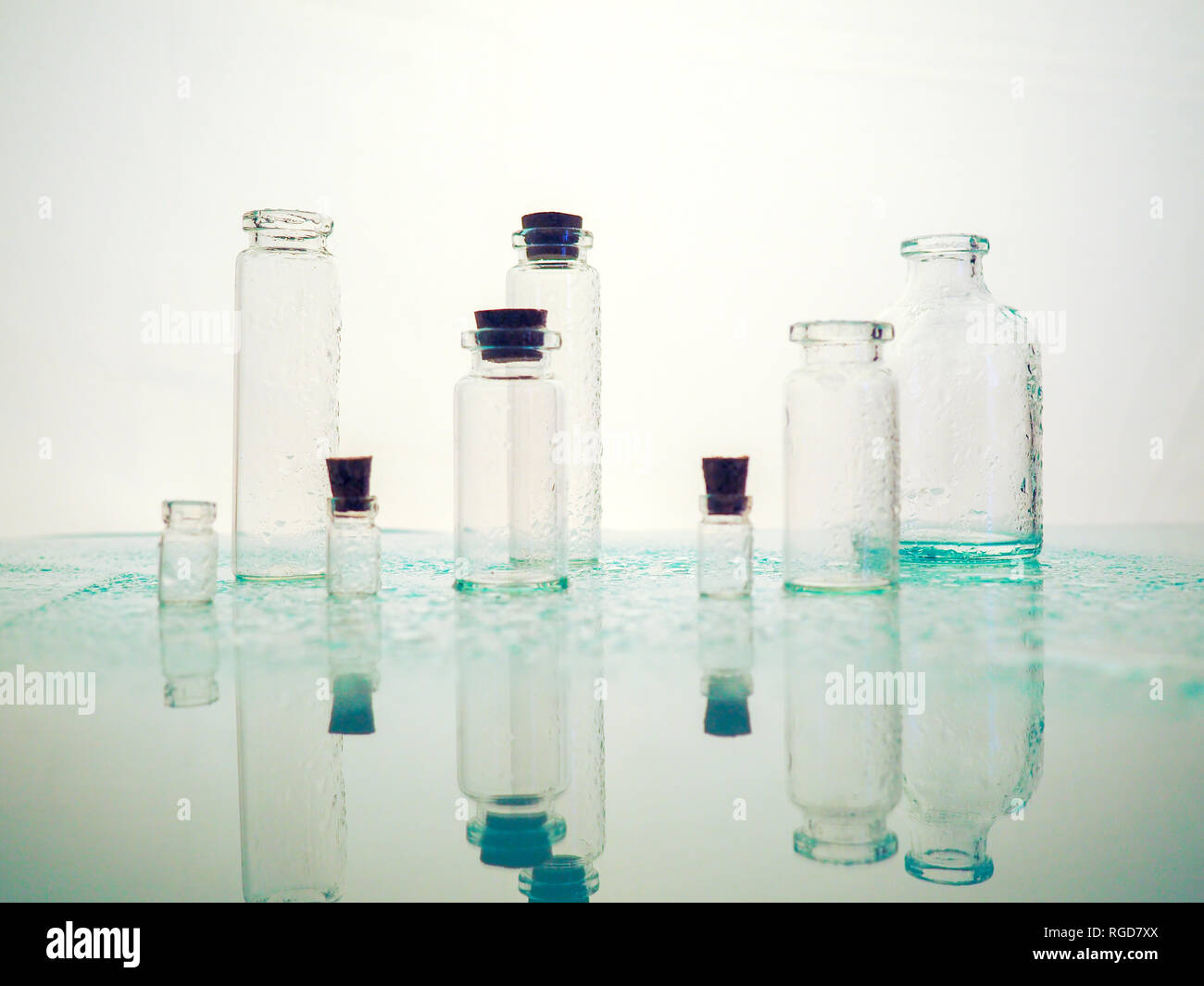 Few transparent bottles, water sprays. empty glass bottles Stock Photo ...