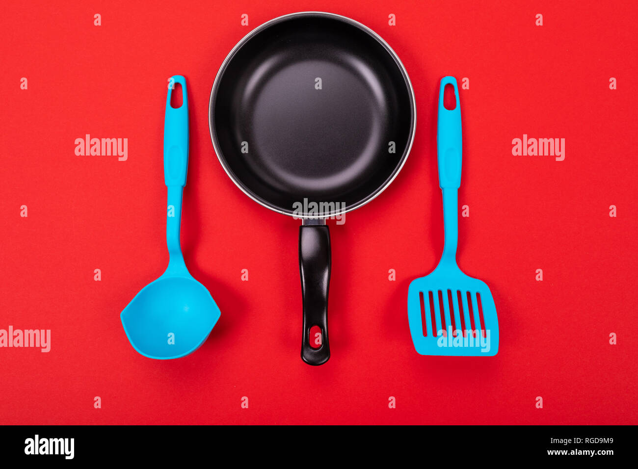 Close-up picture of frying pan with spatula and spoon as kitchen ...