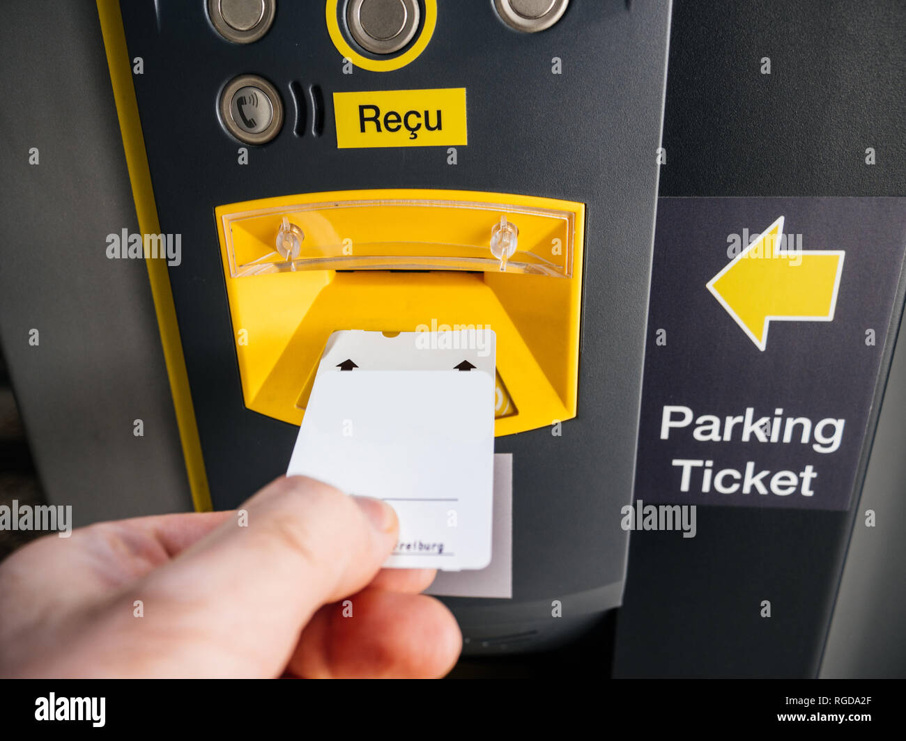Point of view of male hand inserting parking ticket at electronic ...
