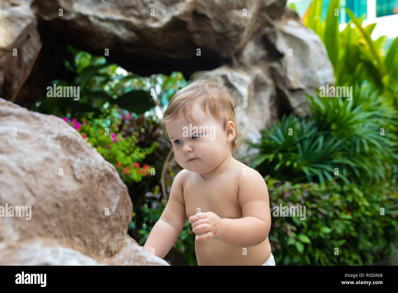 Pretty crawling baby girl smiling and crawling on the wooden brown ...