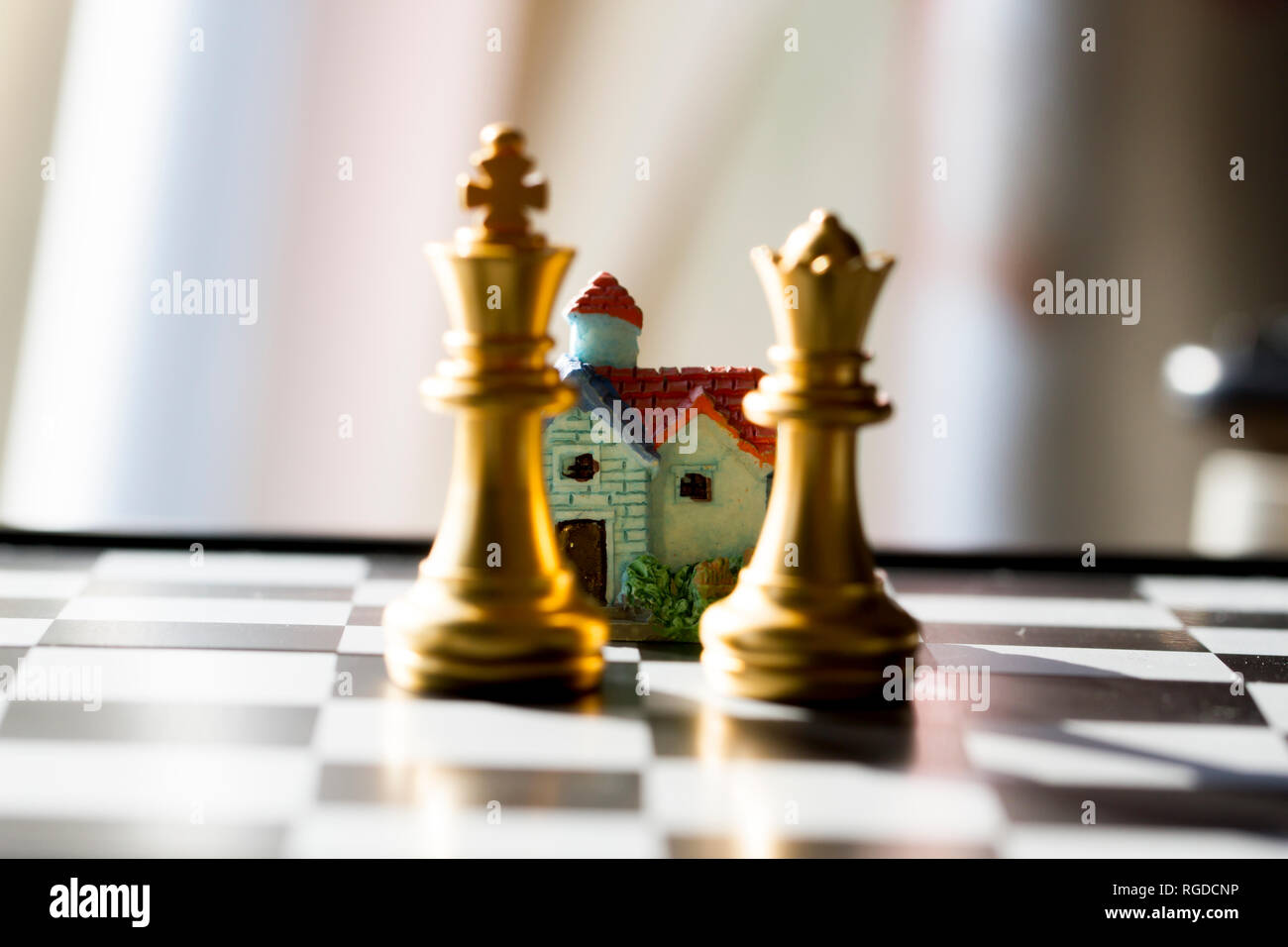 Small house with chess pieces Stock Photo - Alamy