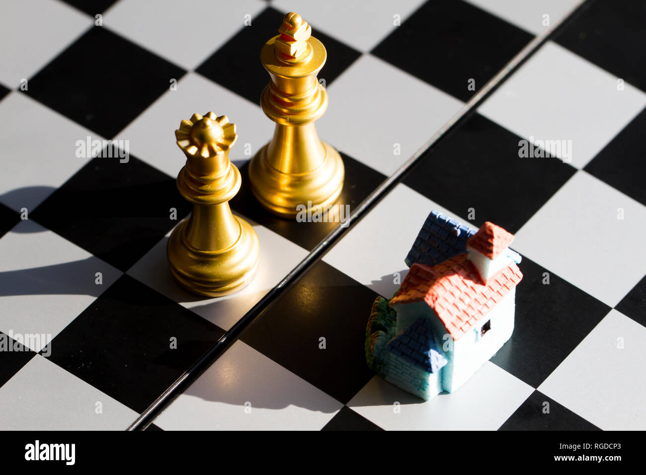 Small house with chess pieces Stock Photo - Alamy