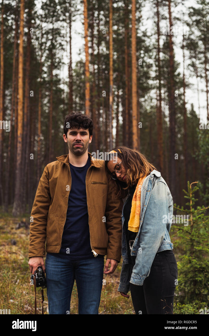 Finland, Lapland, man with camera and woman standing in rural landscape ...