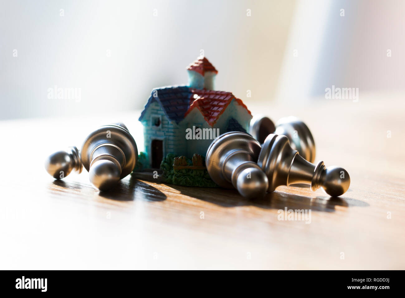 Small house with chess pieces Stock Photo - Alamy
