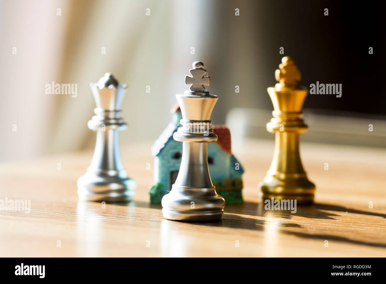 Small house with chess pieces Stock Photo - Alamy
