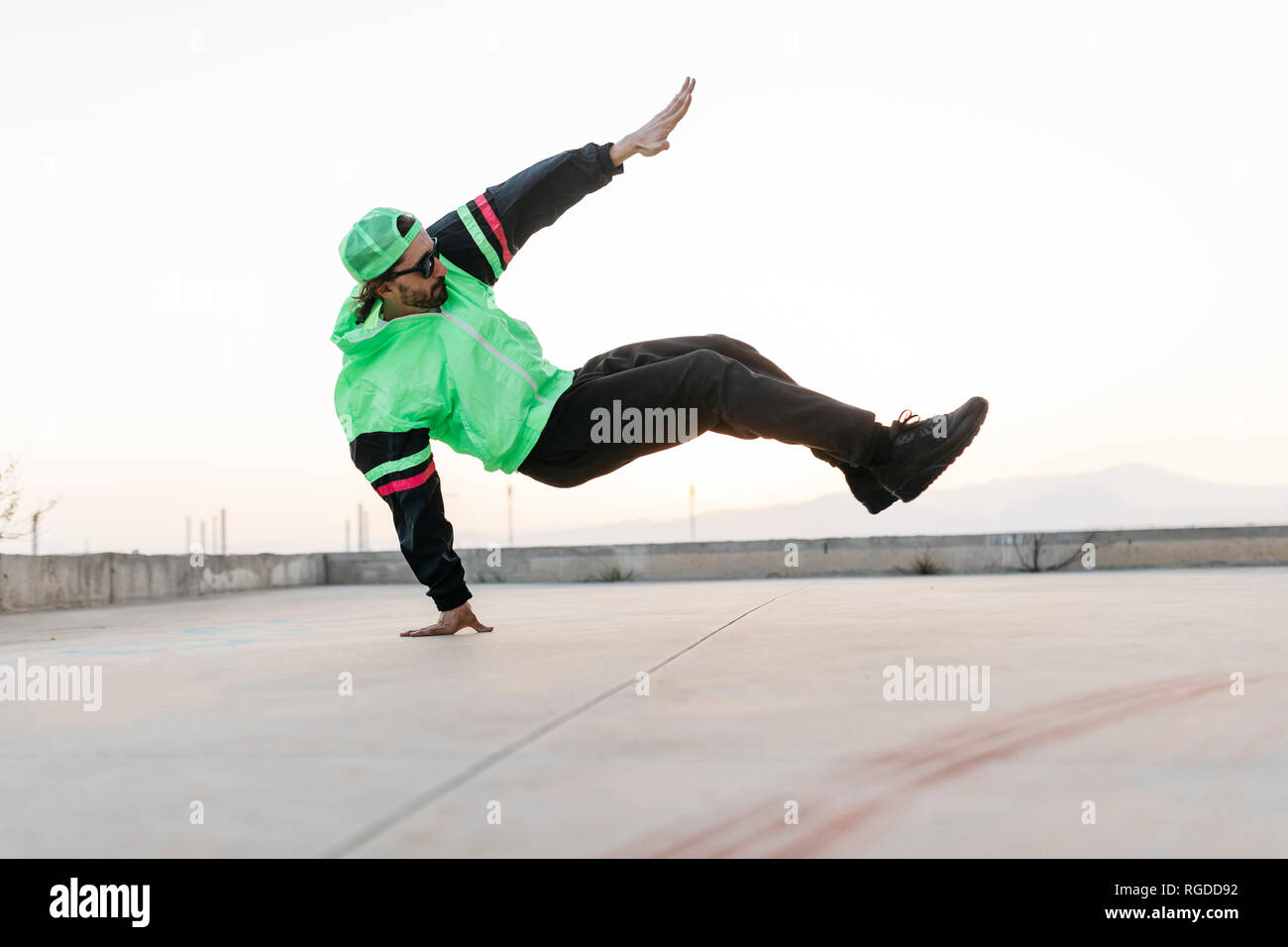 Man doing breakdance in urban concrete building, standing on hand Stock ...