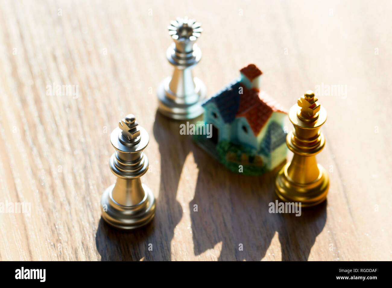 Small house with chess pieces Stock Photo - Alamy