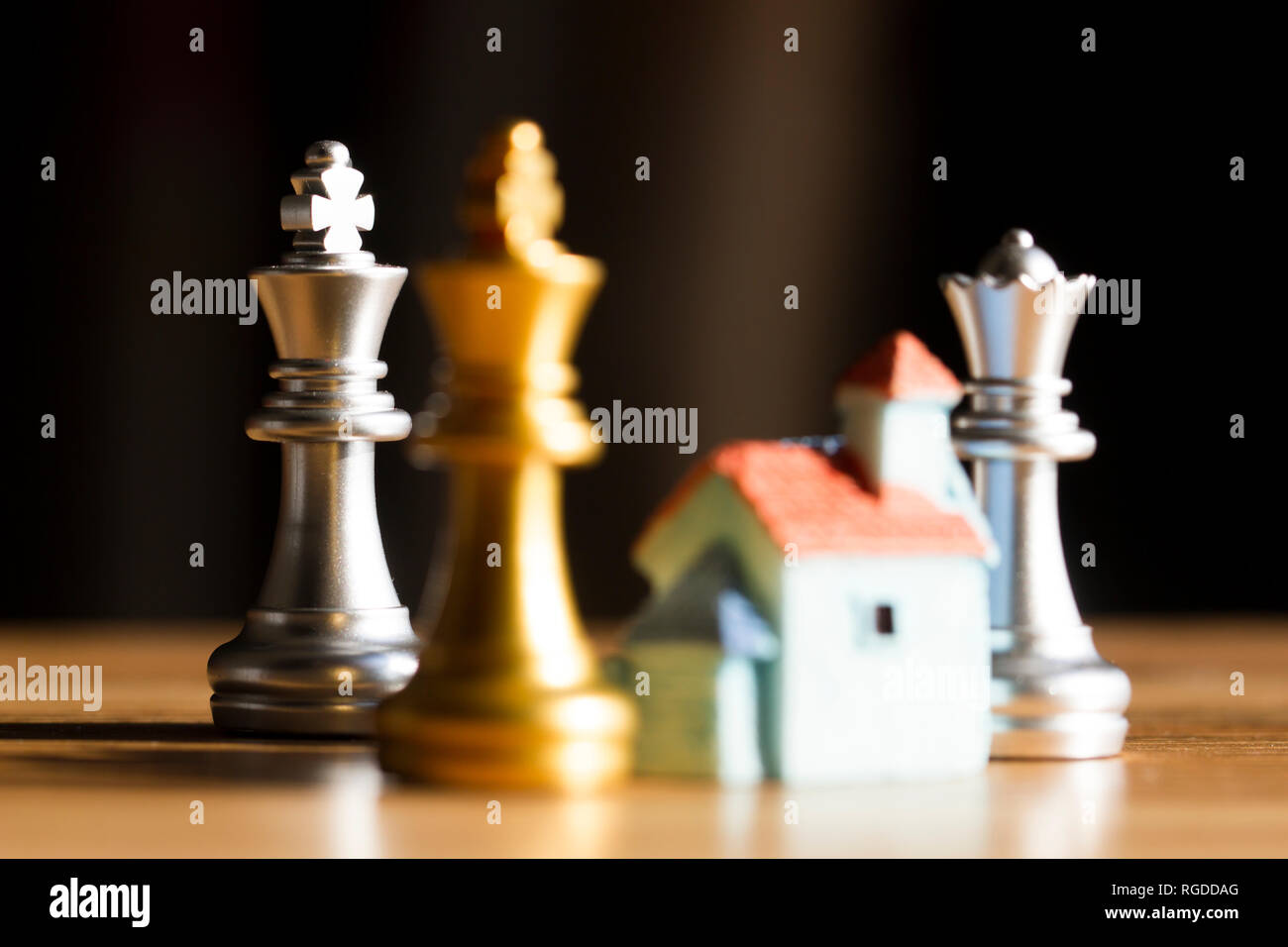Small house with chess pieces Stock Photo - Alamy