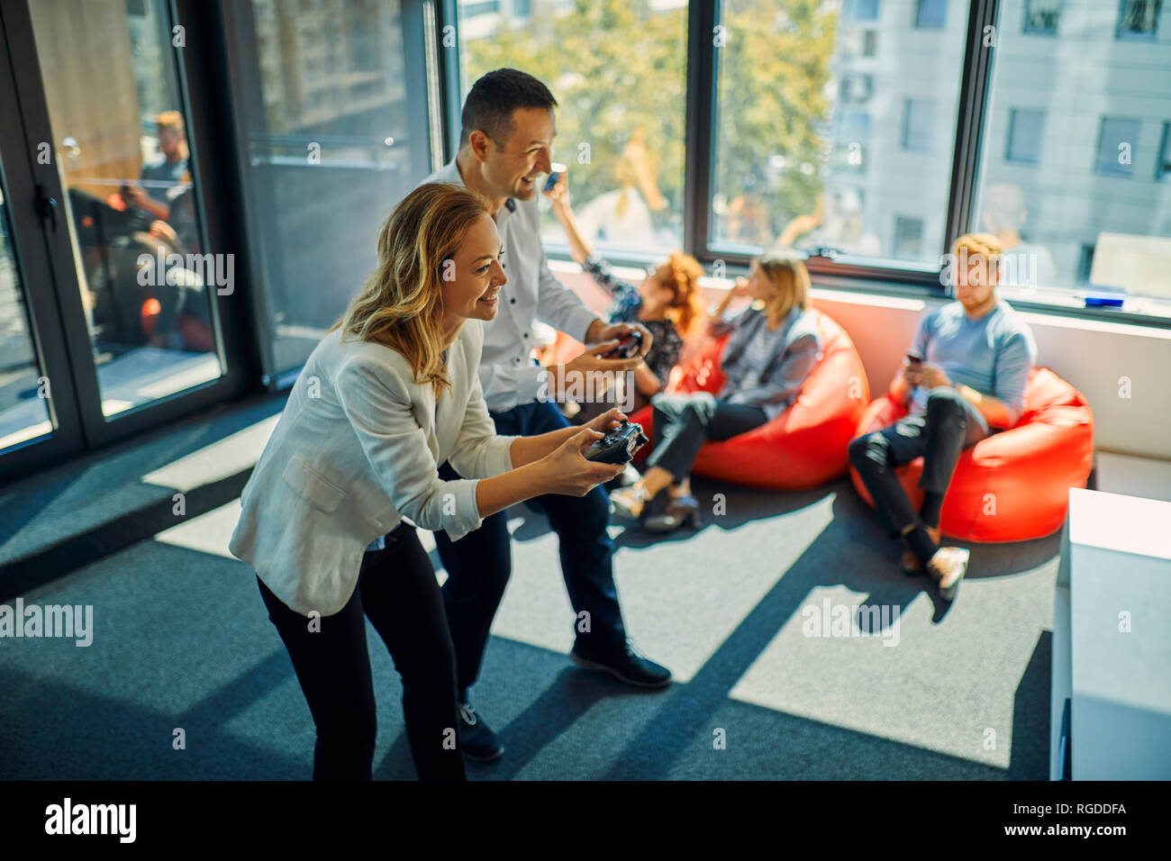 Colleagues playing video game in office Stock Photo - Alamy