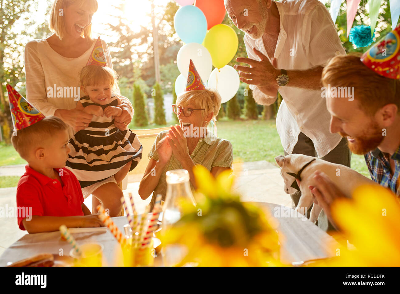 Happy extended family on a garden birthday party Stock Photo - Alamy
