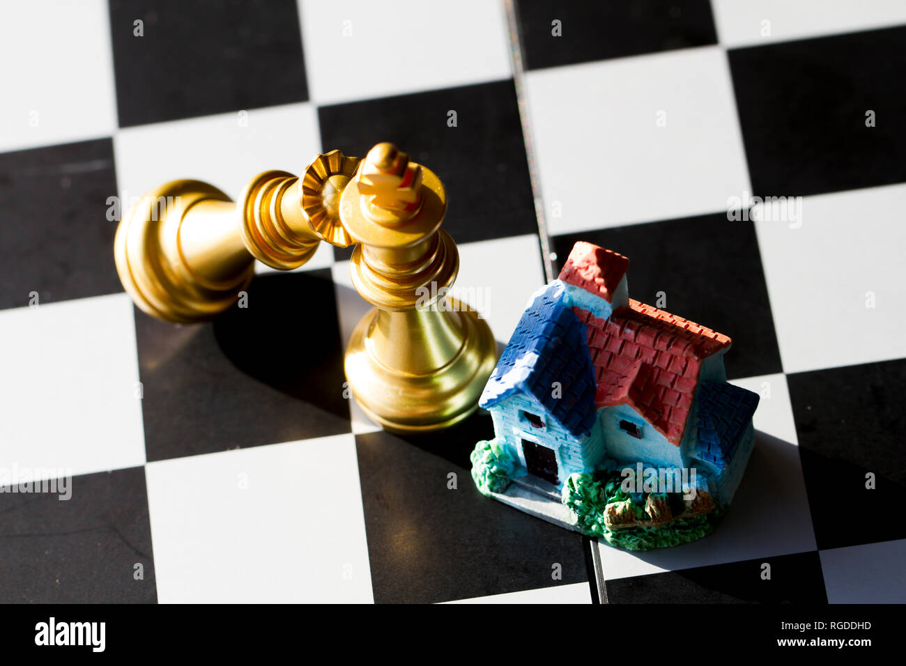Small house with chess pieces Stock Photo - Alamy