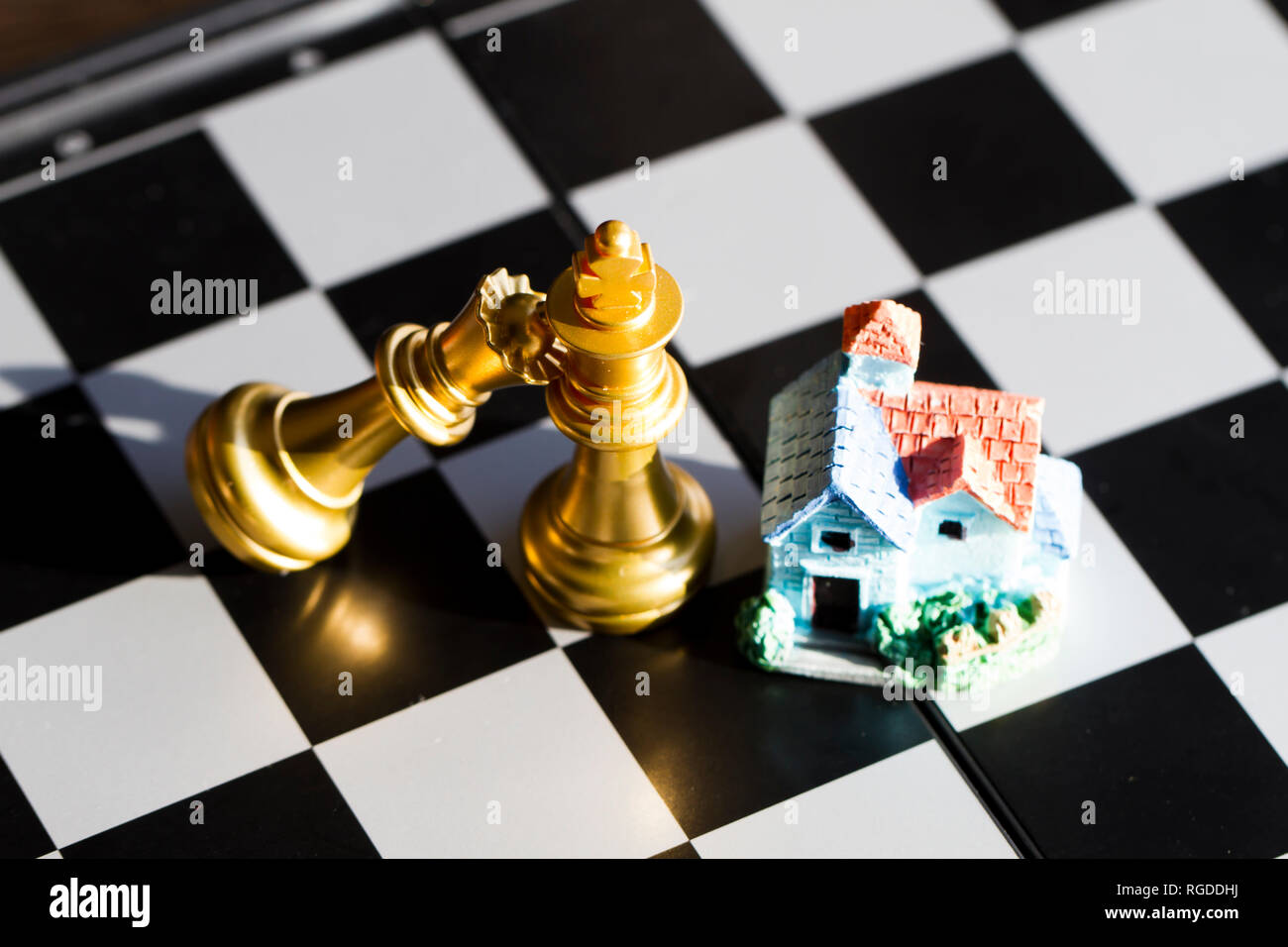 Small house with chess pieces Stock Photo - Alamy