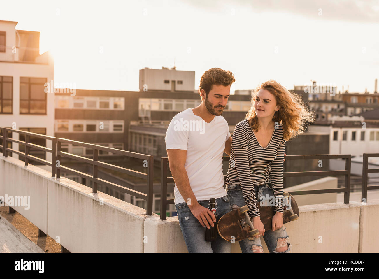 Couple relaxing roof terrace hi-res stock photography and images - Alamy