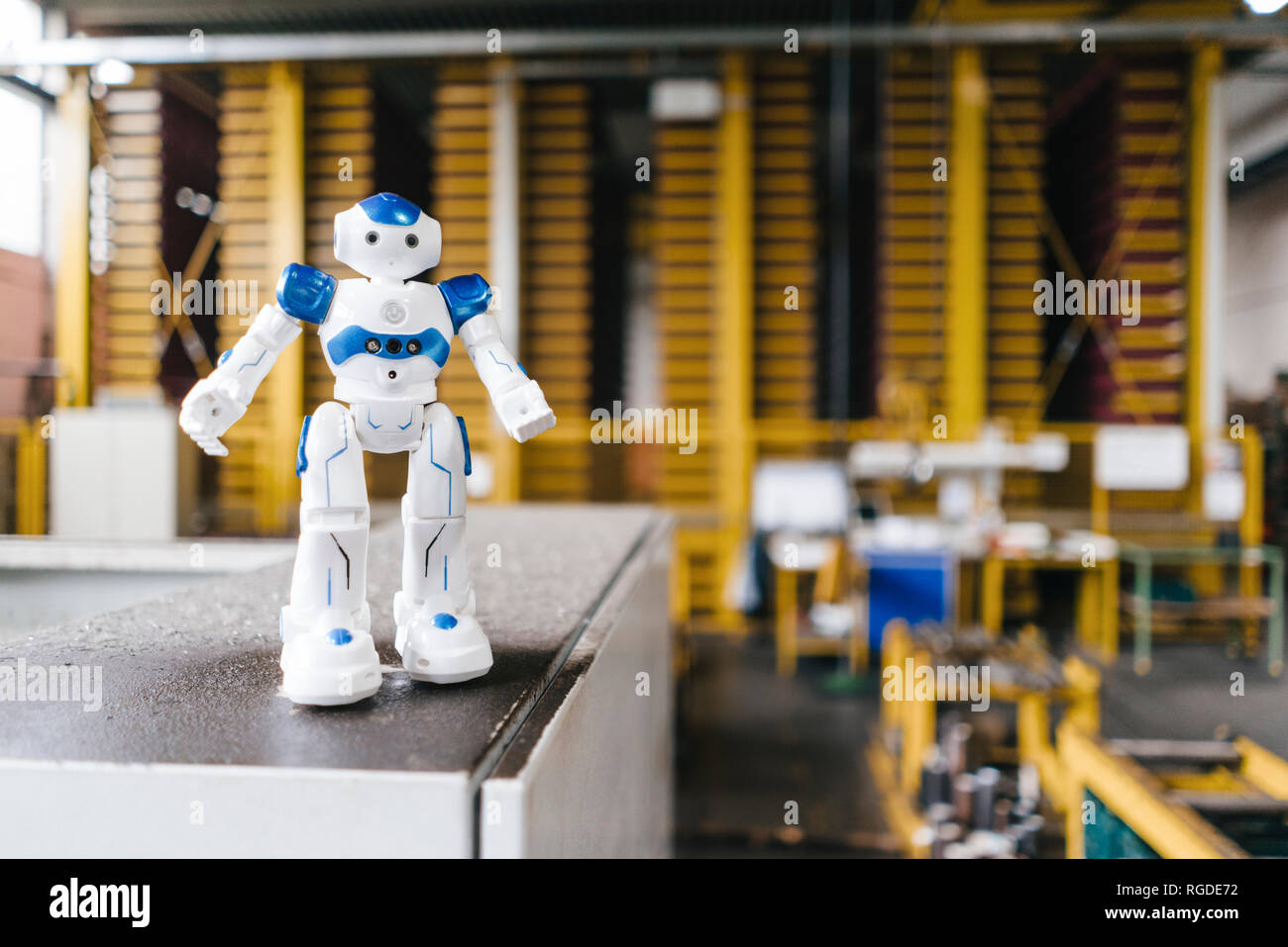 Toy robot standing on shelf in logistics center Stock Photo - Alamy