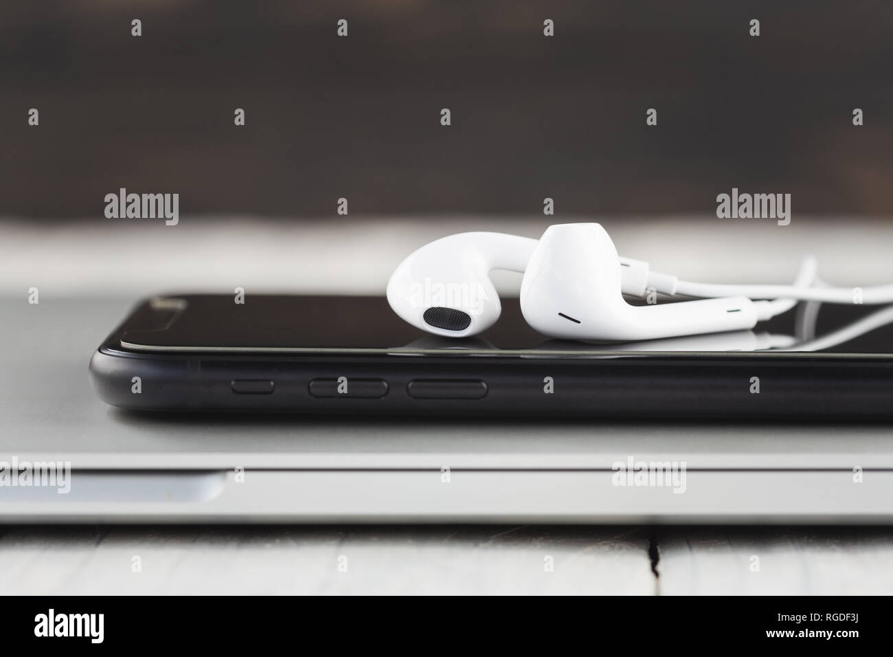 close-up phone and headphone stack on laptop computer front view Stock ...