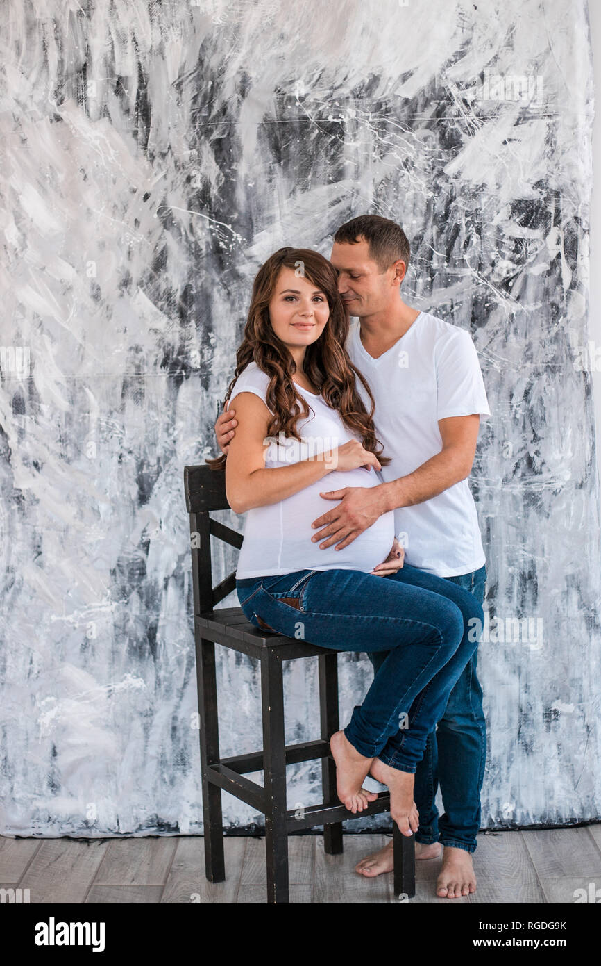Pregnant couple hug and hold pregnant belly Stock Photo - Alamy