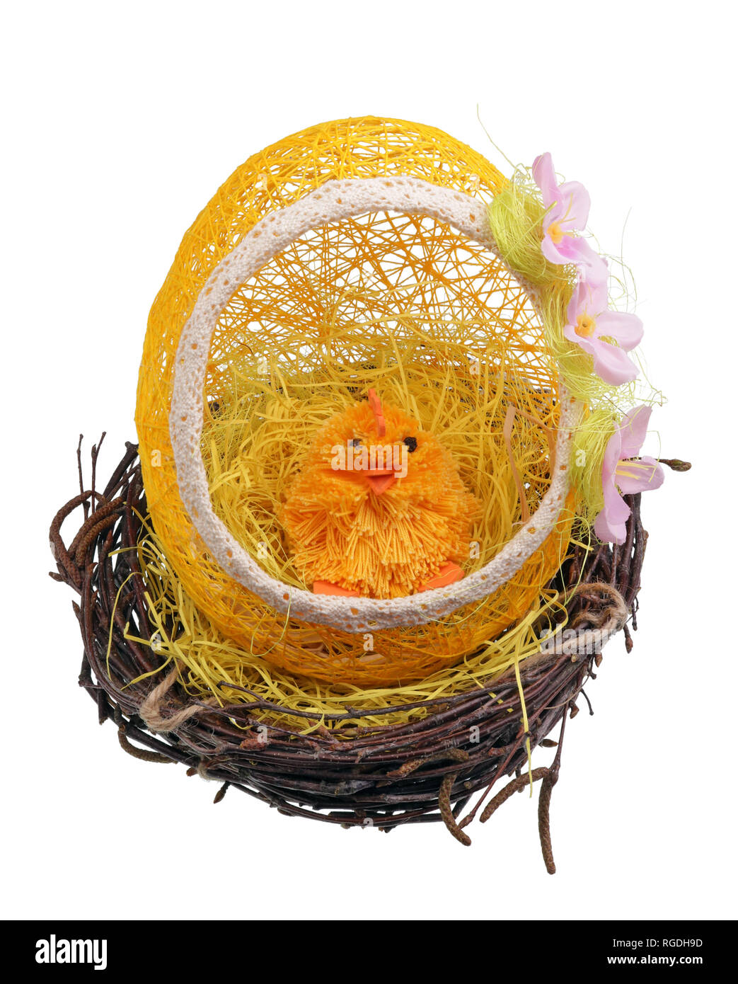 Easter handmade egg and chicken made of thread and paper in a nest of ...