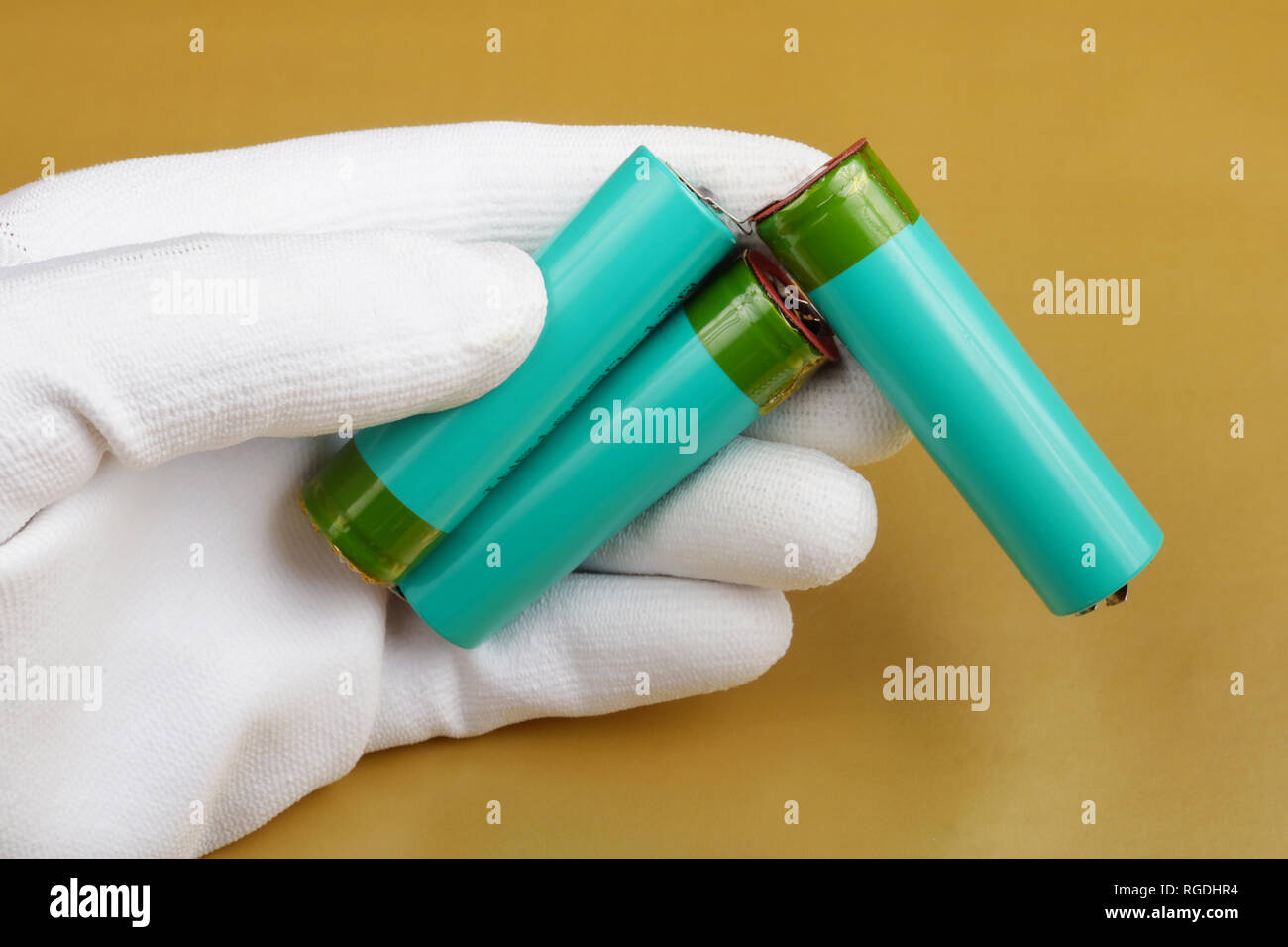 A technician controls the quality of a new alkaline batteries for home ...