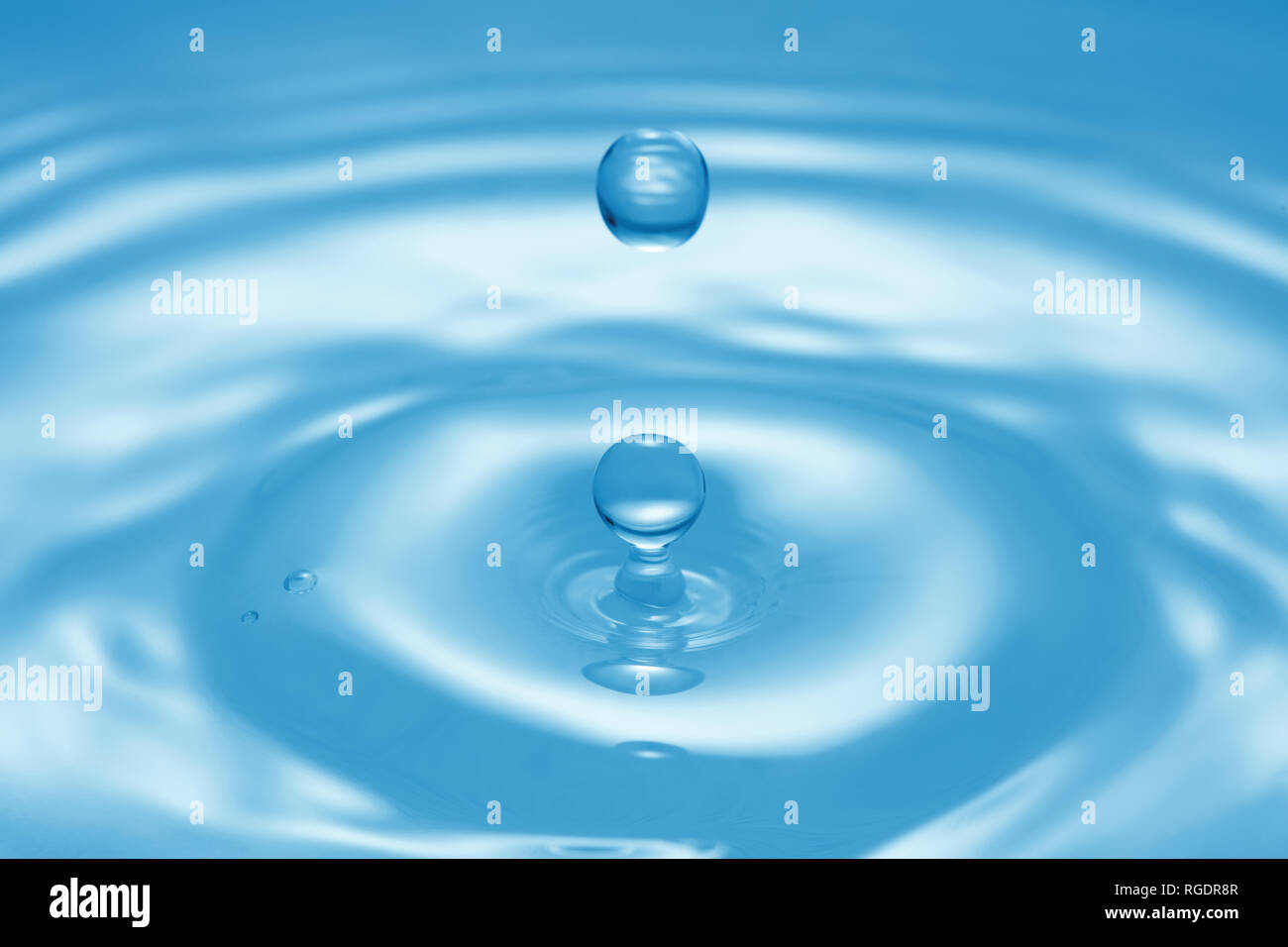 water splash on pure blue water surface Stock Photo - Alamy