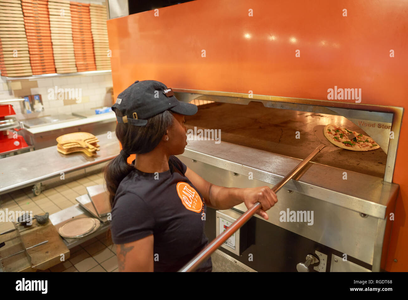 CHICAGO, IL - CIRCA MARCH, 2016: worker cook pizza at Blaze Pizza ...