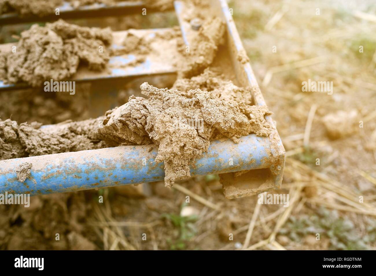 Picture of processing seeds through mud and machine Stock Photo - Alamy