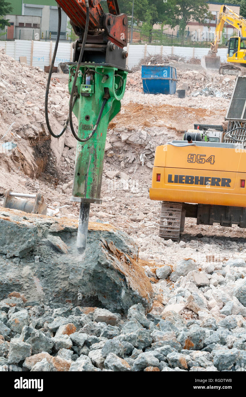Deconstruction site. Hydrolic rock breaker destroying concrete ...