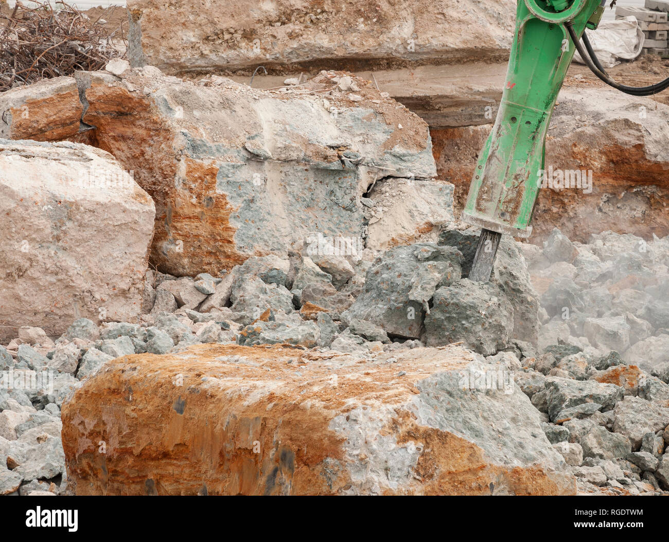 Deconstruction site. Hydrolic rock breaker destroying concrete ...