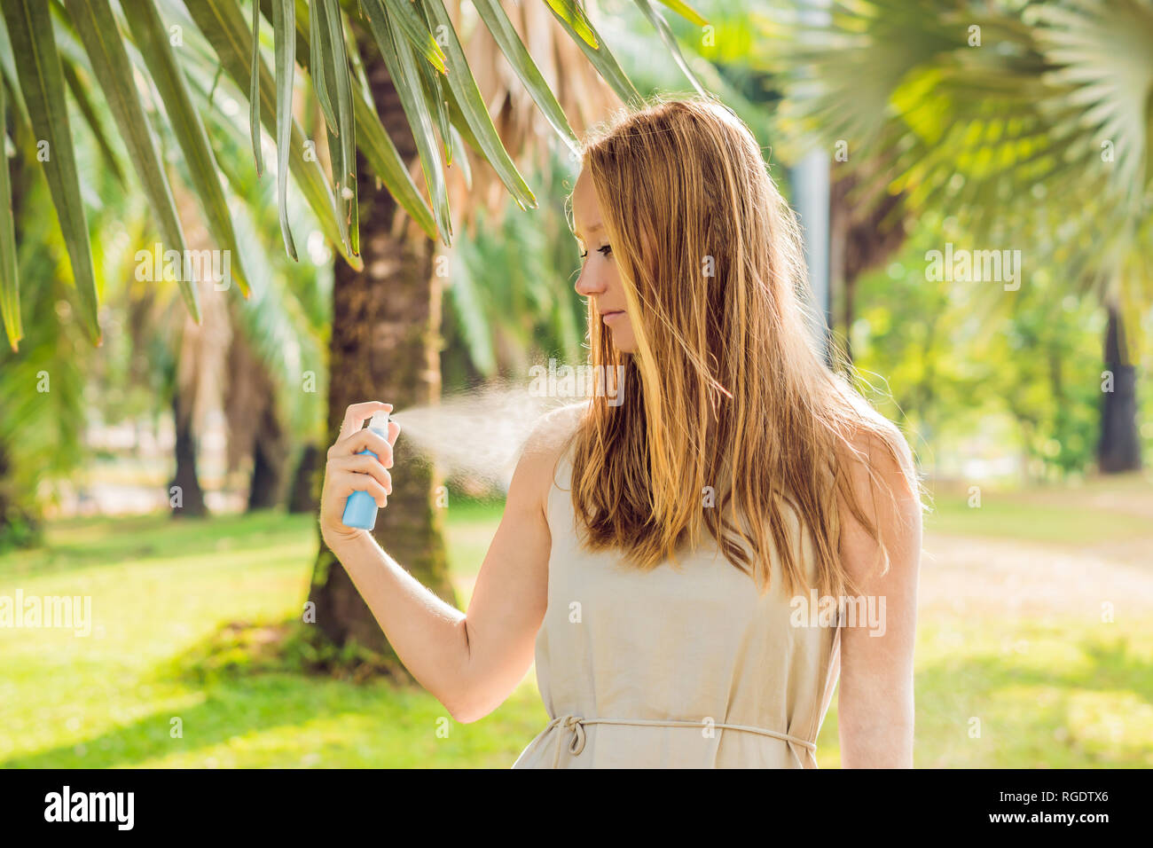 Woman spraying insect repellent on skin outdoor Stock Photo - Alamy