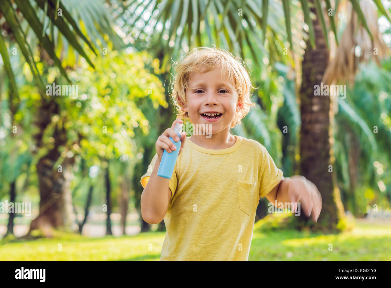 Boy spraying insect repellents on skin Stock Photo - Alamy