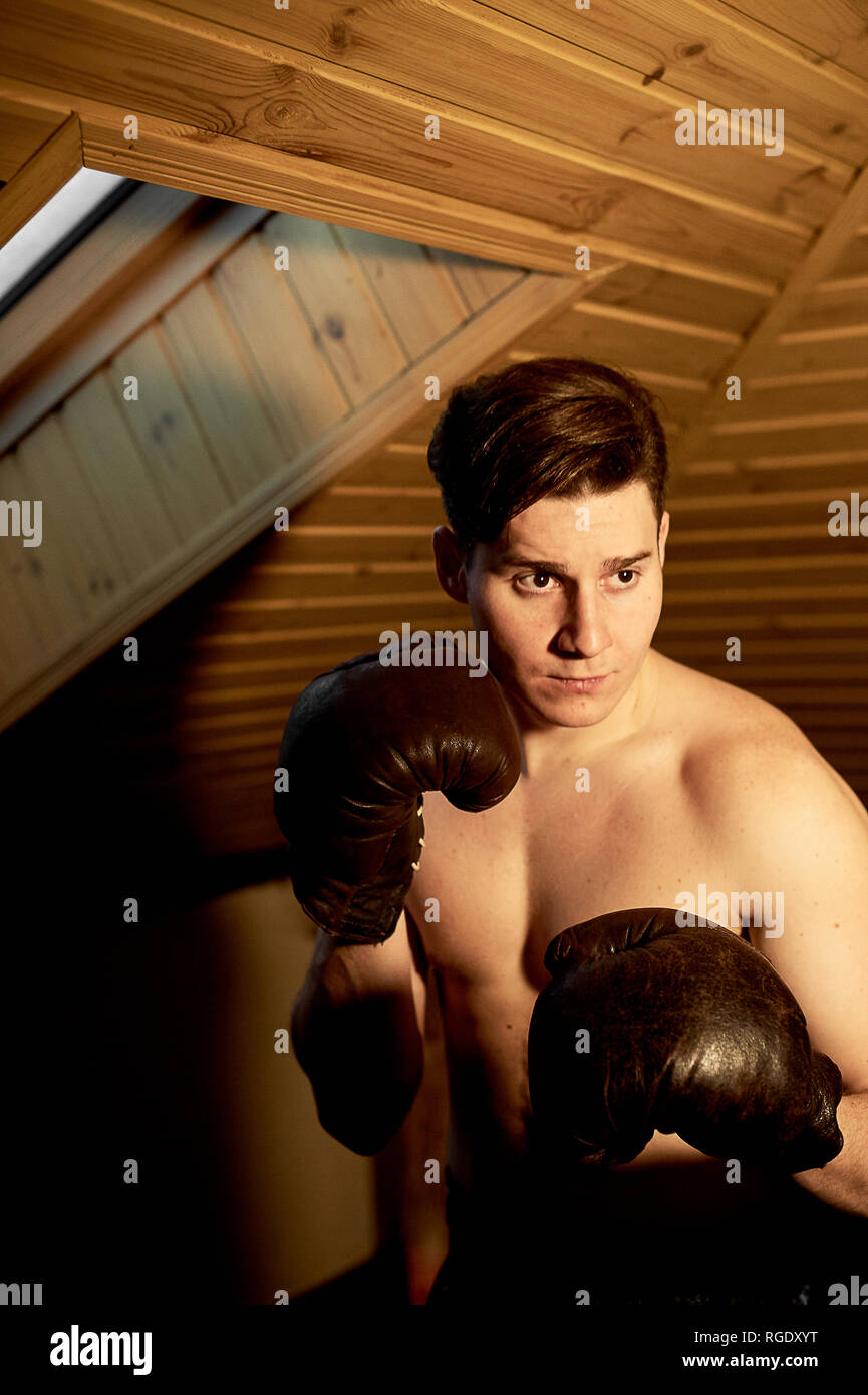 A young strong man trains in Boxing. Aggressiveness, sports and a ...