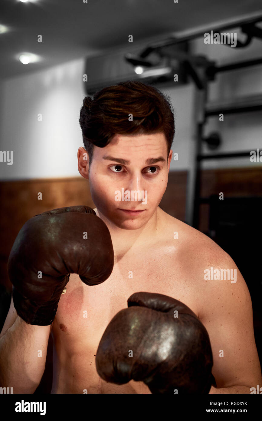 A young strong man trains in Boxing. Aggressiveness, sports and a ...