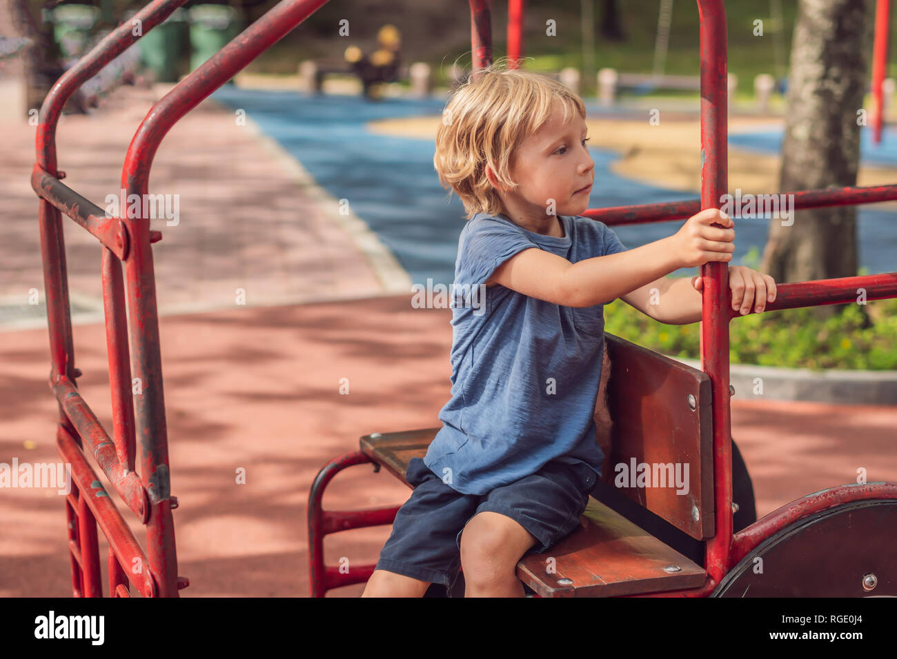 Funny cute happy baby playing on the playground. The emotion of ...