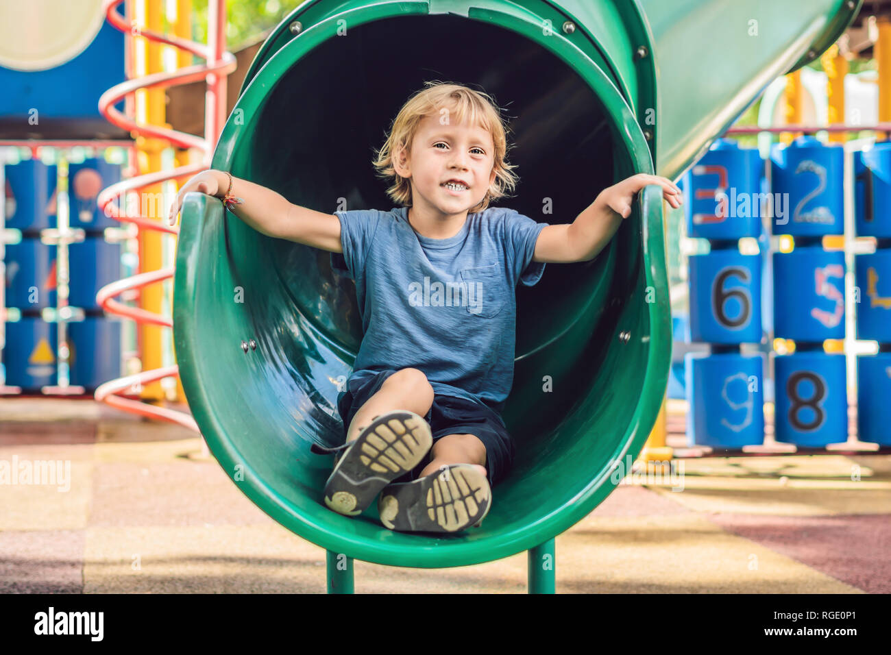 Funny cute happy baby playing on the playground. The emotion of ...
