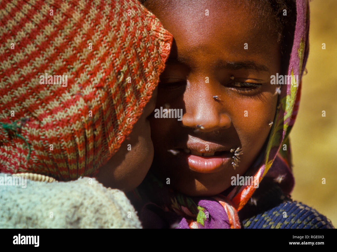 TIMIMOUN, ALGERIA - JANUARY 18, 2002: two unknown children with flies ...