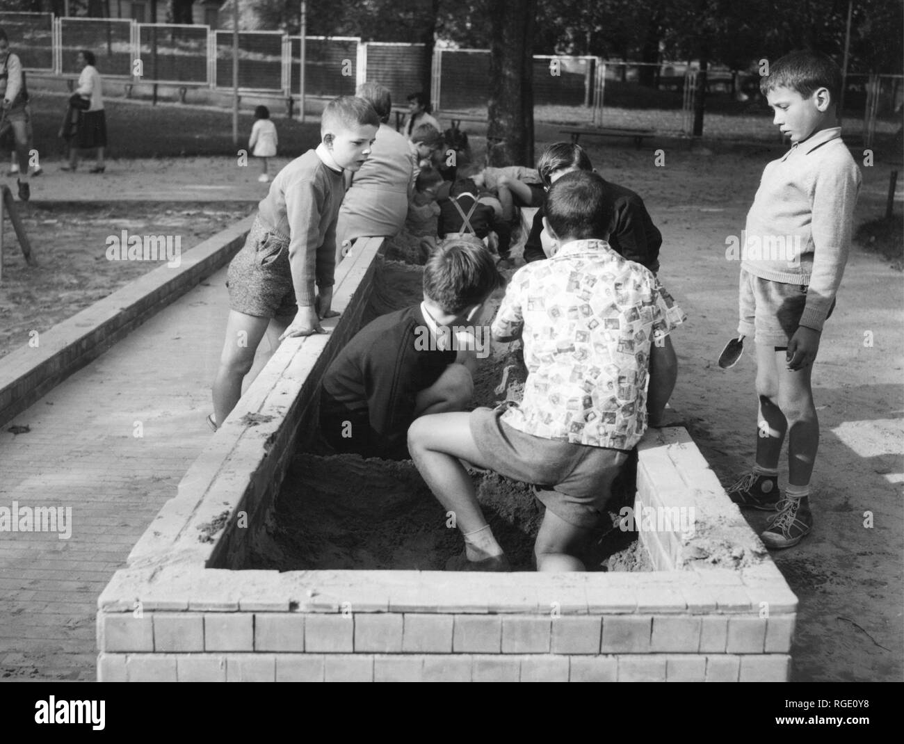 Children playing playground city Black and White Stock Photos & Images ...