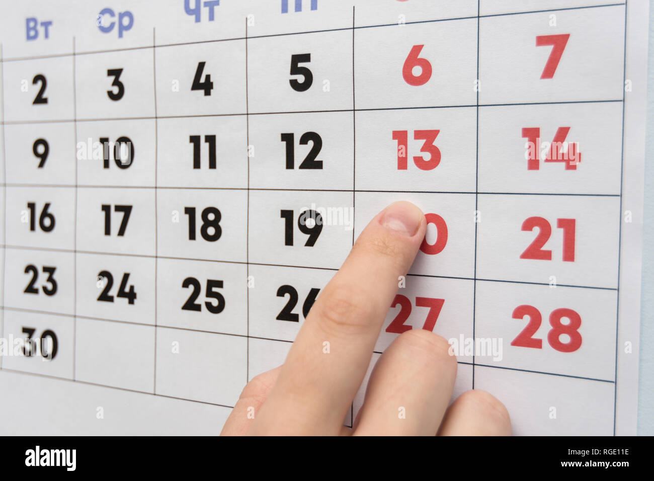 Hand pointing to the day off Saturday on a wall calendar Stock Photo ...