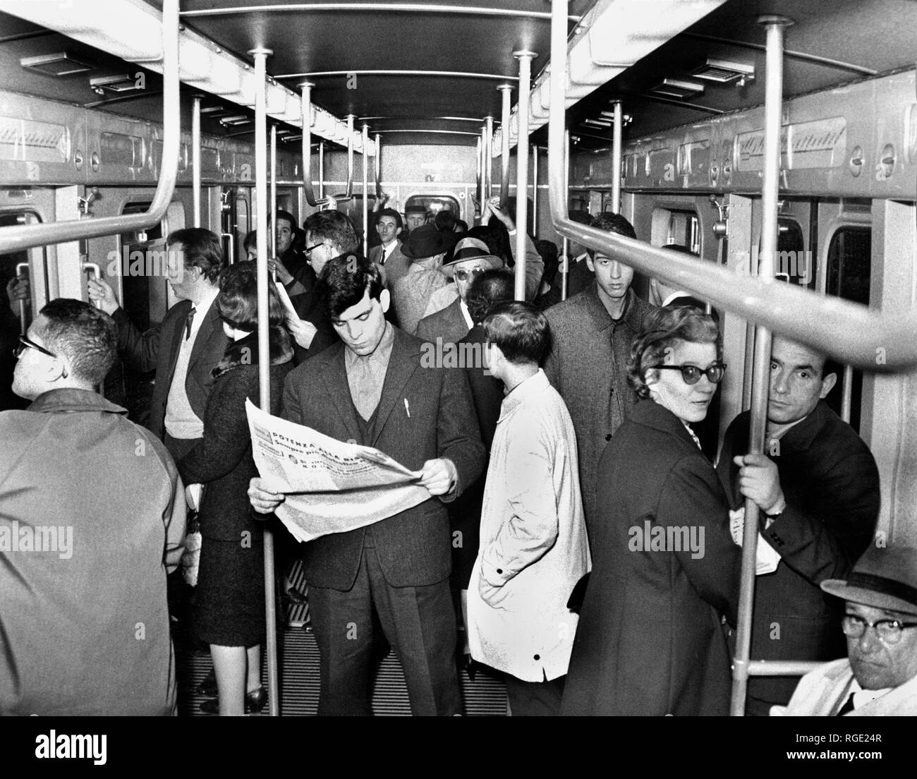 People Reading Newspaper On Train