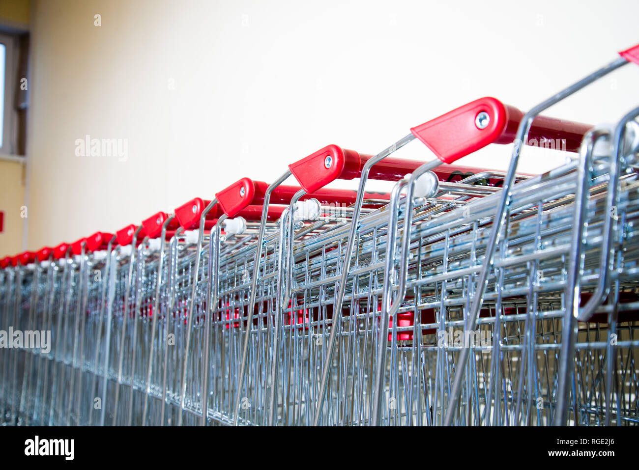 Shopping carts lined up together close up . Many empty shopping carts ...