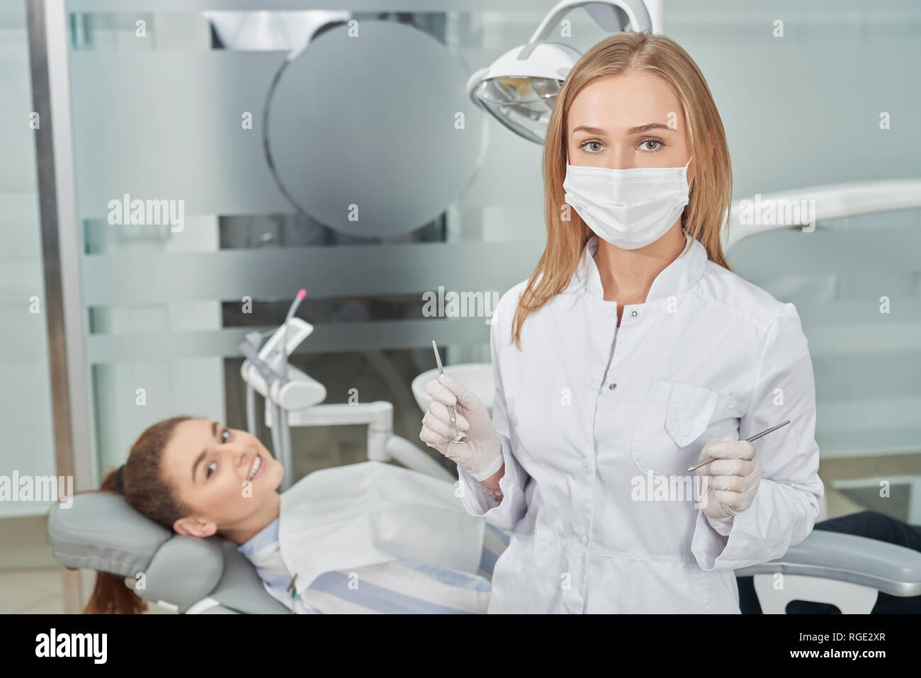 Professional doctor and happy patient posing, looking at camera ...