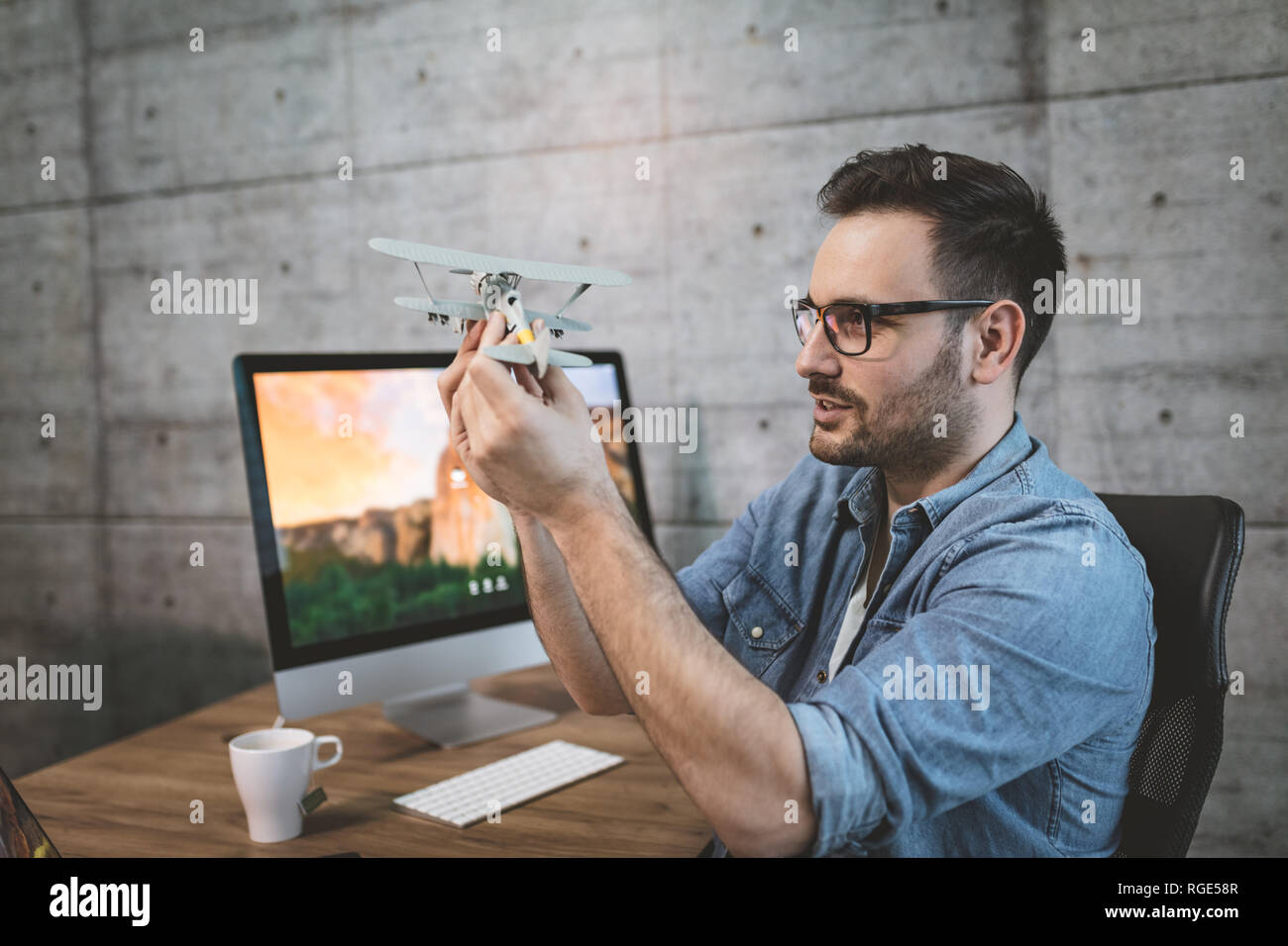 Young handsome successful freelance entrepreneur having fun and showing ...