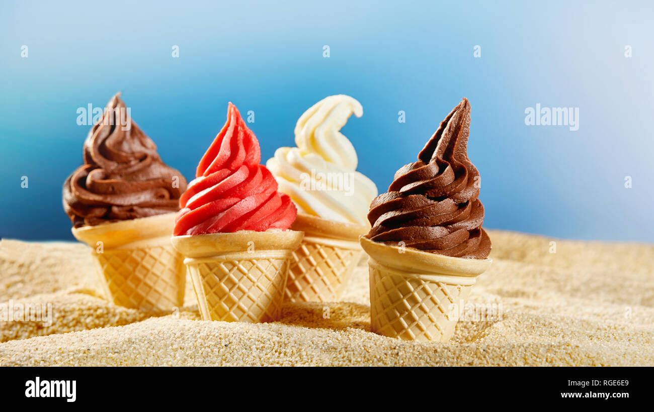 Colourful ice cream in crunchy cones stuck into sand Stock Photo - Alamy
