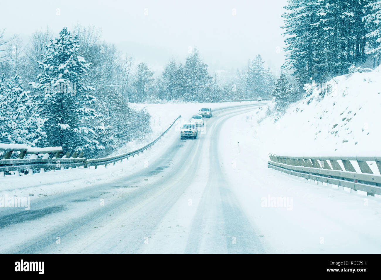 Traffic cars on winter road in snow blizzard Stock Photo - Alamy