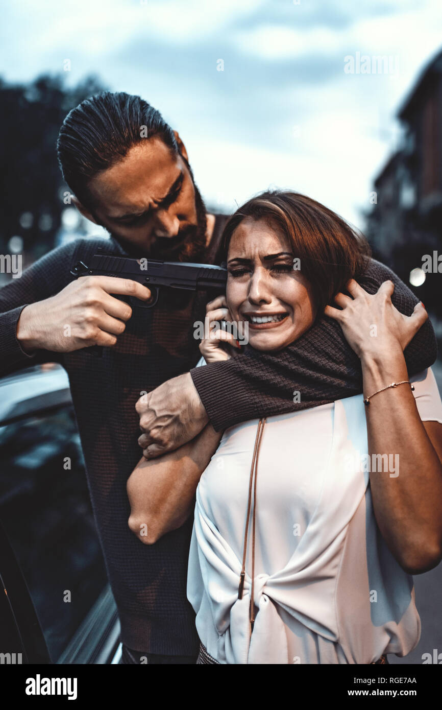 A dangerous criminal threaten a young woman with gun to tell him where ...