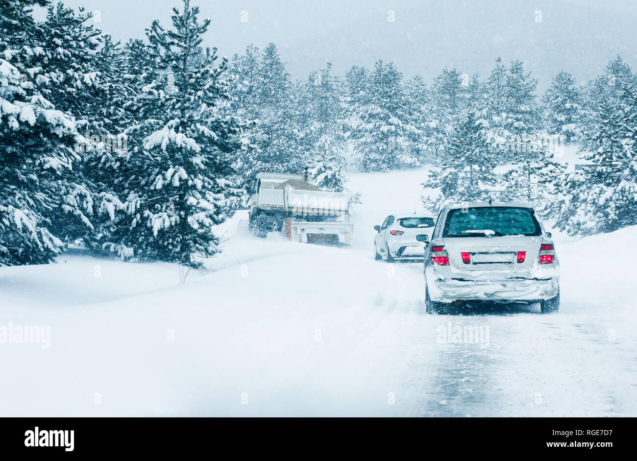 Traffic cars on winter road in snow blizzard Stock Photo - Alamy