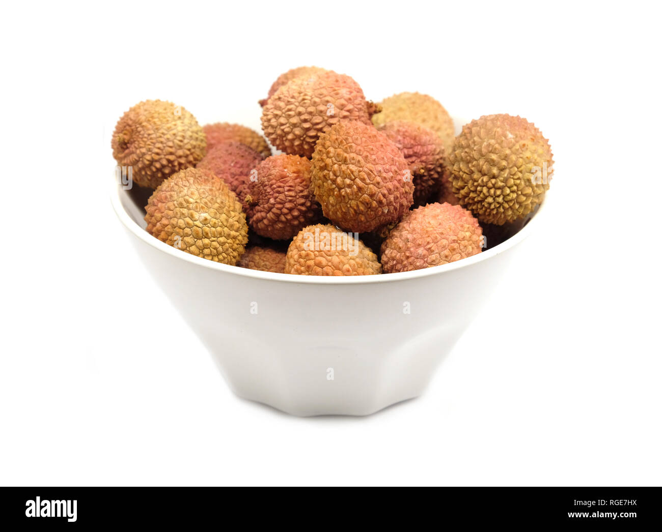 Many ripe lychee fruits isolated in white bowl front view closeup Stock ...